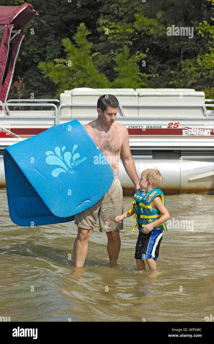 Kids with their inflatable boat at the lake Stock Photo - Alamy