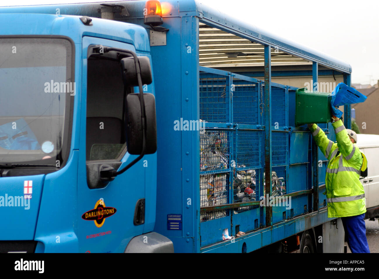 Council workman loading domestic waste on to a lorry for recycling ...