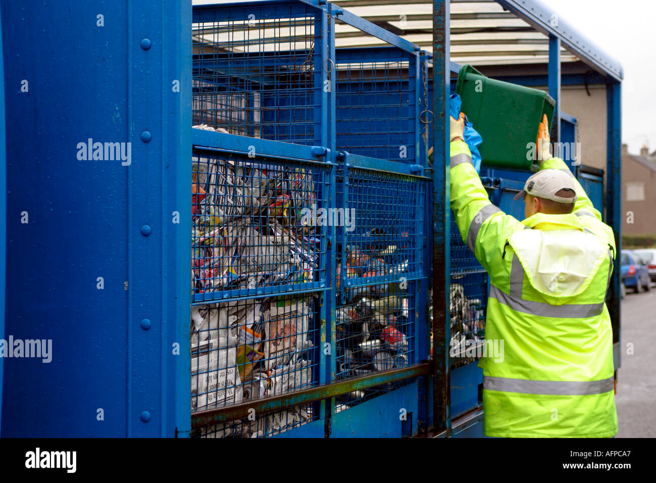 Council workman loading domestic waste on to a lorry for recycling ...