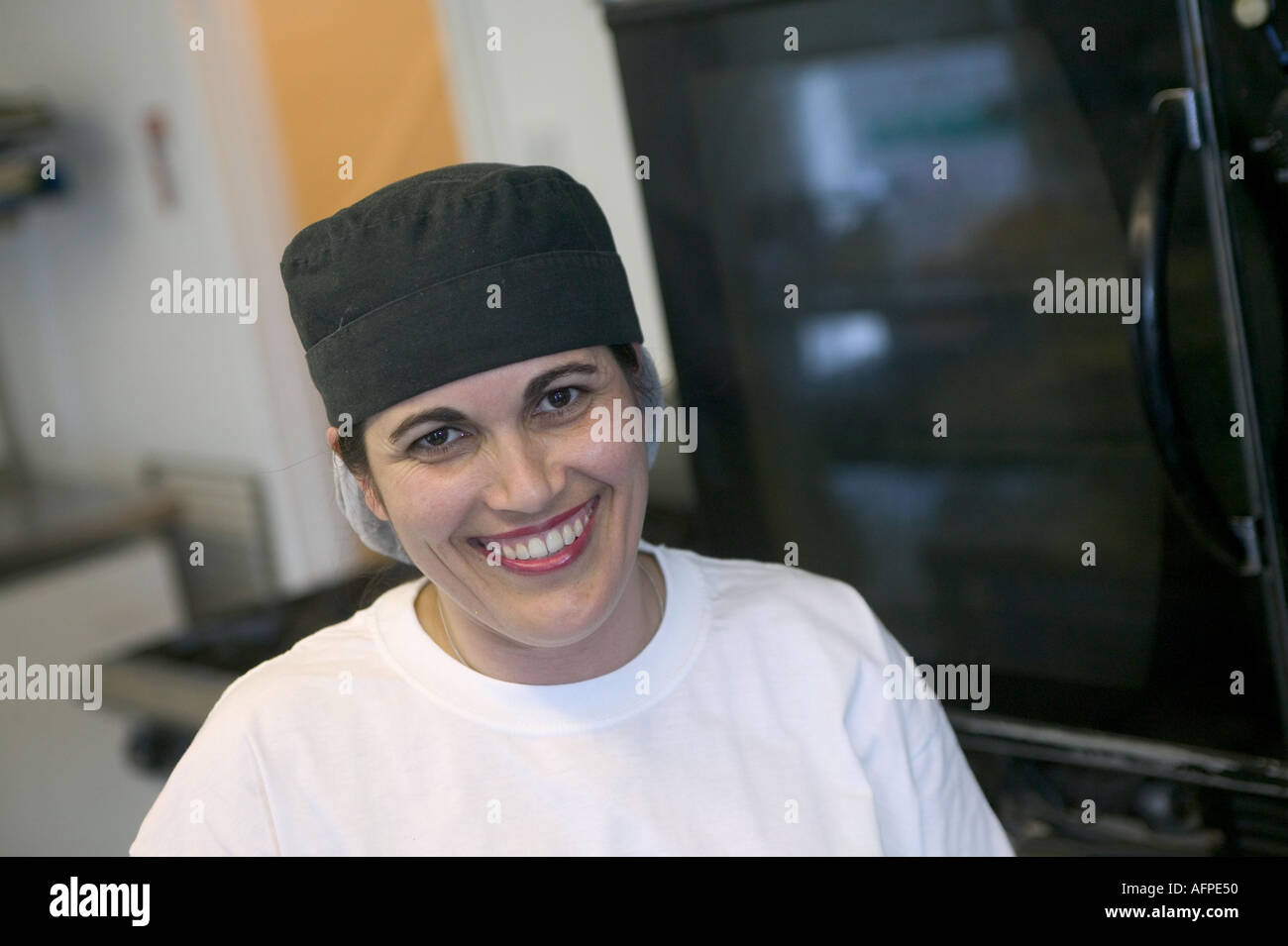 Kitchen Worker smiling Stock Photo - Alamy
