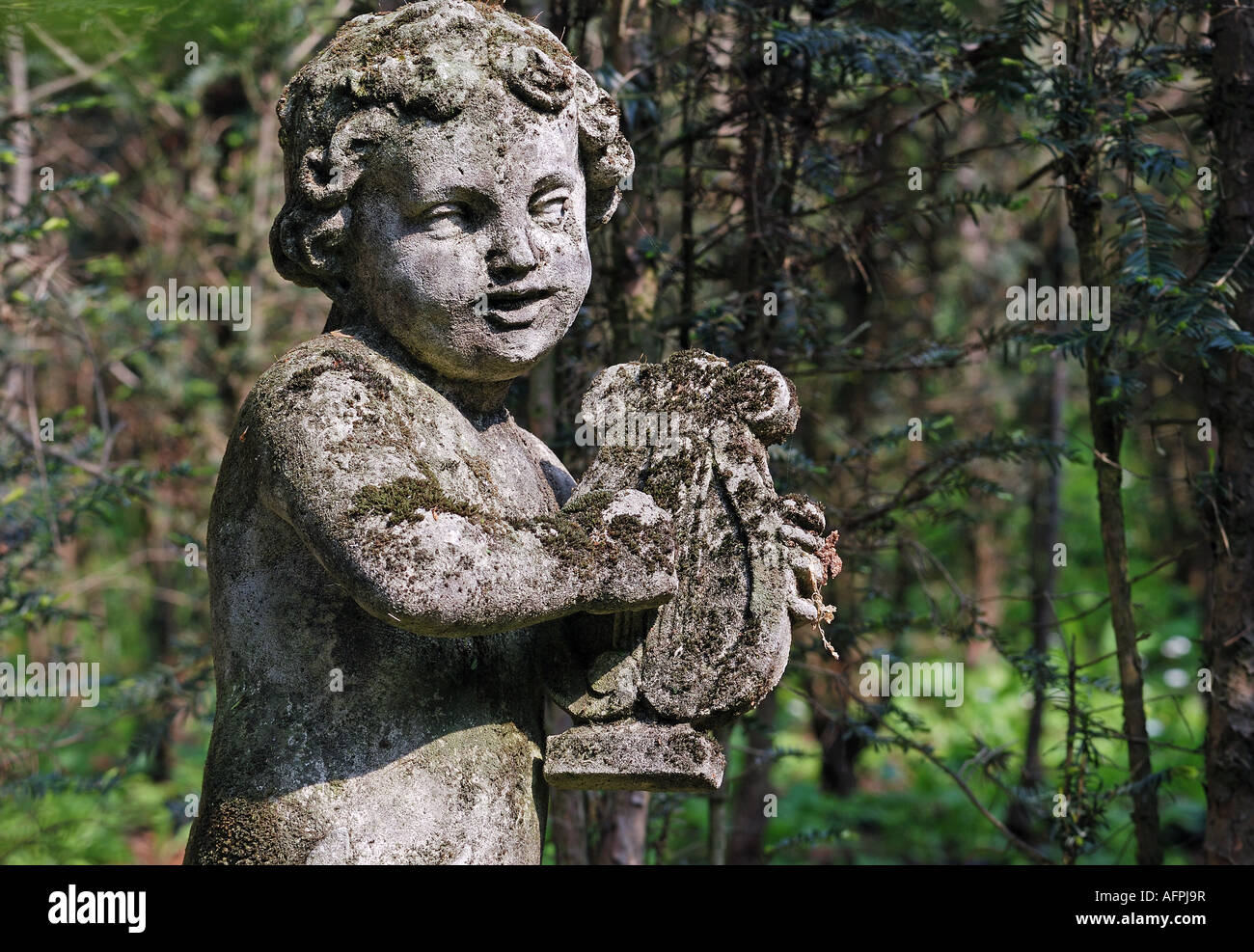 Statue of a child in an Italian garden Stock Photo - Alamy