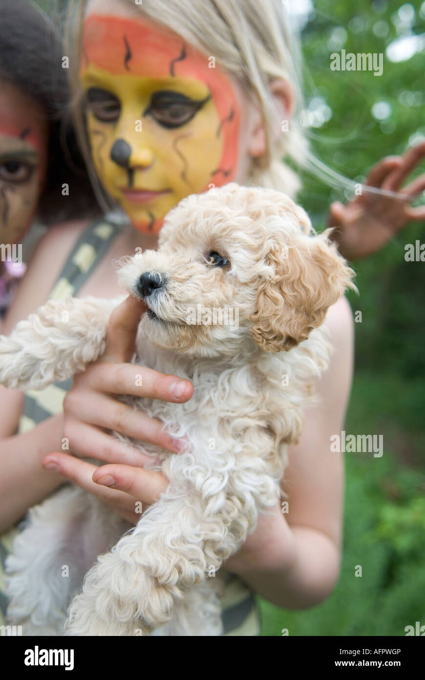 Painted girl with puppy Stock Photo - Alamy