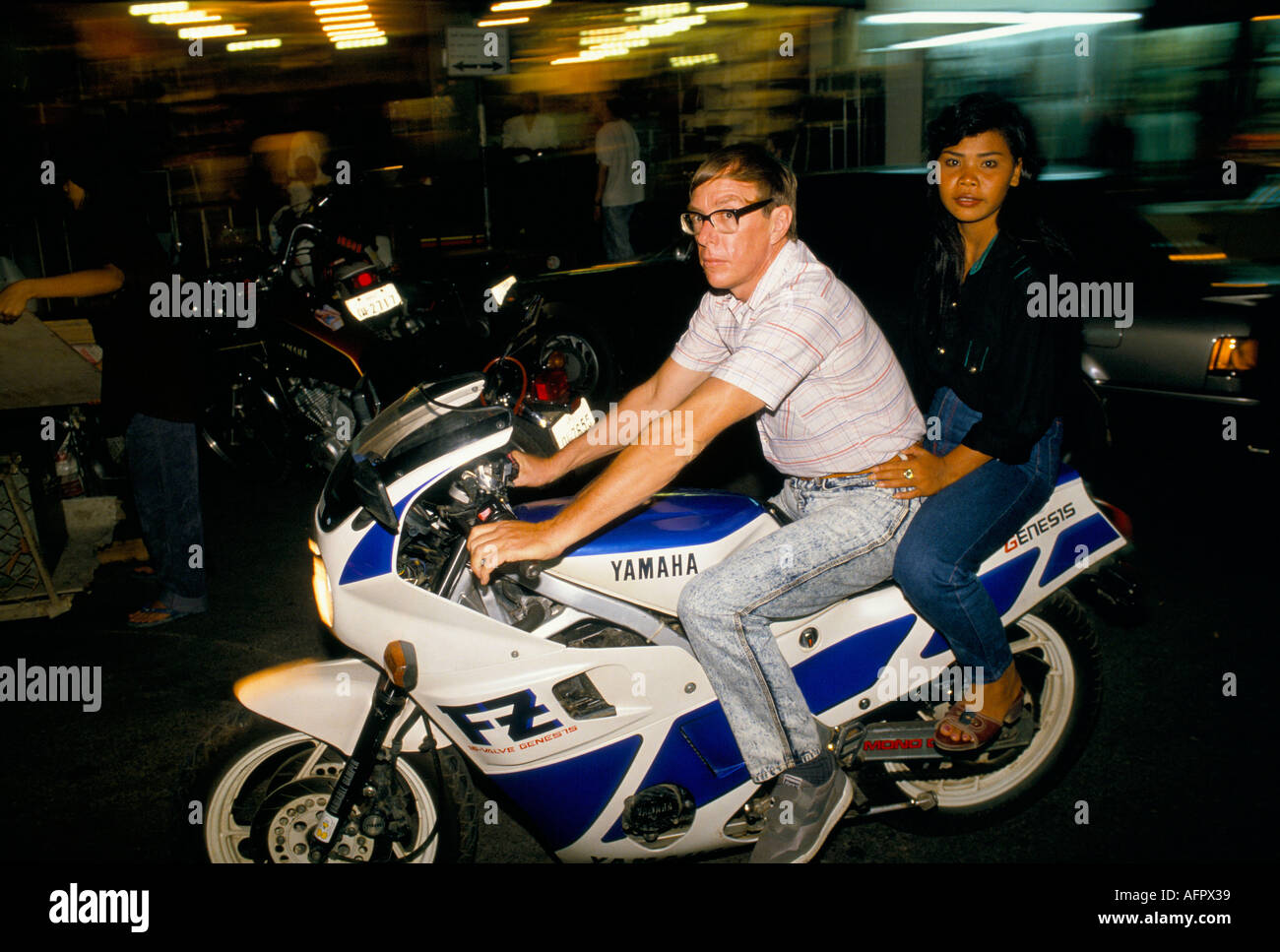 Sex worker with sex tourist on hired motor bike Pattaya Thailand. 1990s ...