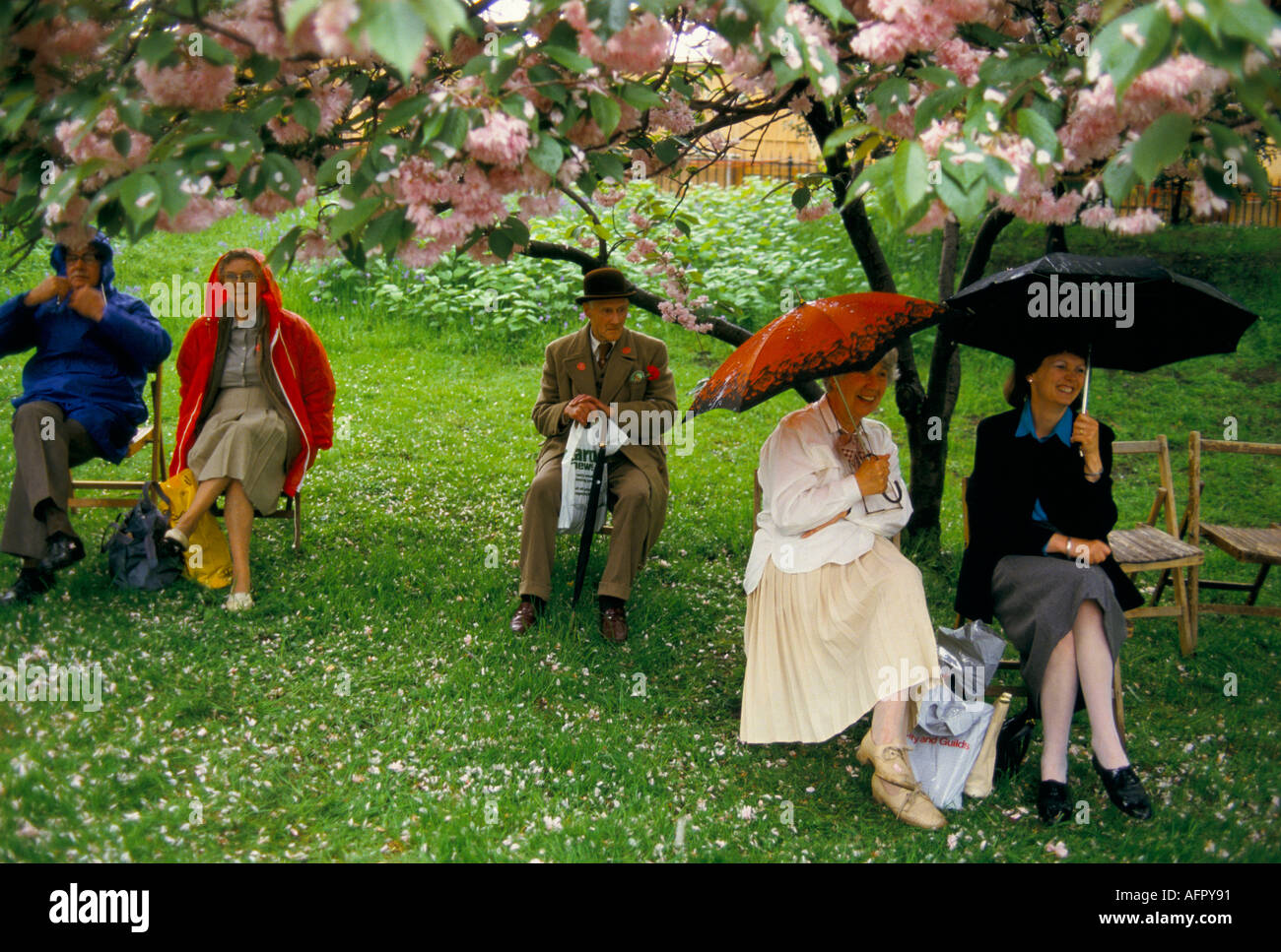 Woman sheltering under an umbrella on a wet rainy day hi-res stock ...