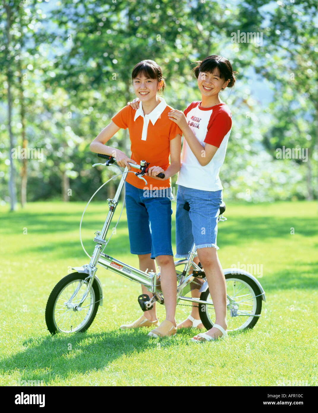 Two girls ride outdoor bicycles hi-res stock photography and images - Alamy