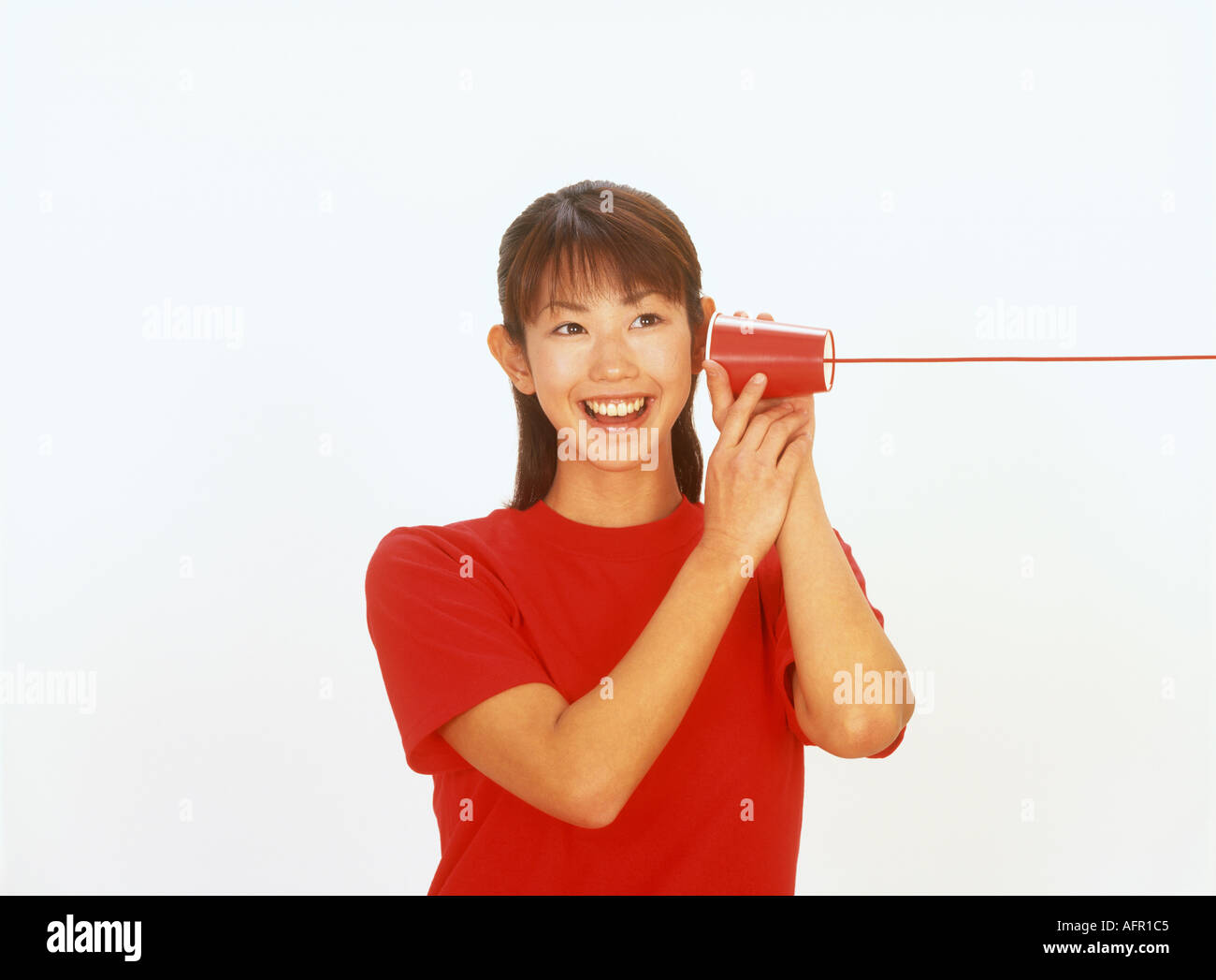 Japanese Woman Listening on String Telephone Stock Photo - Alamy