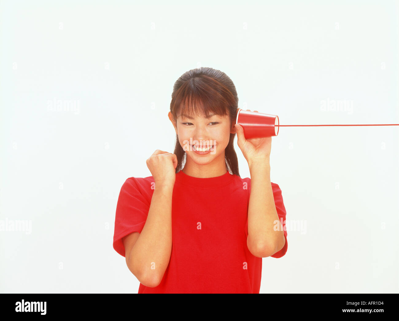Japanese Woman Listening on String Telephone Stock Photo - Alamy