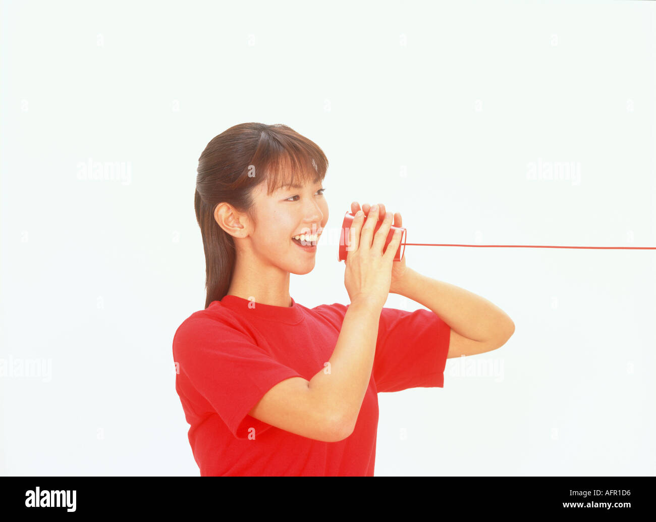 Japanese Woman Talking on String Telephone Stock Photo - Alamy
