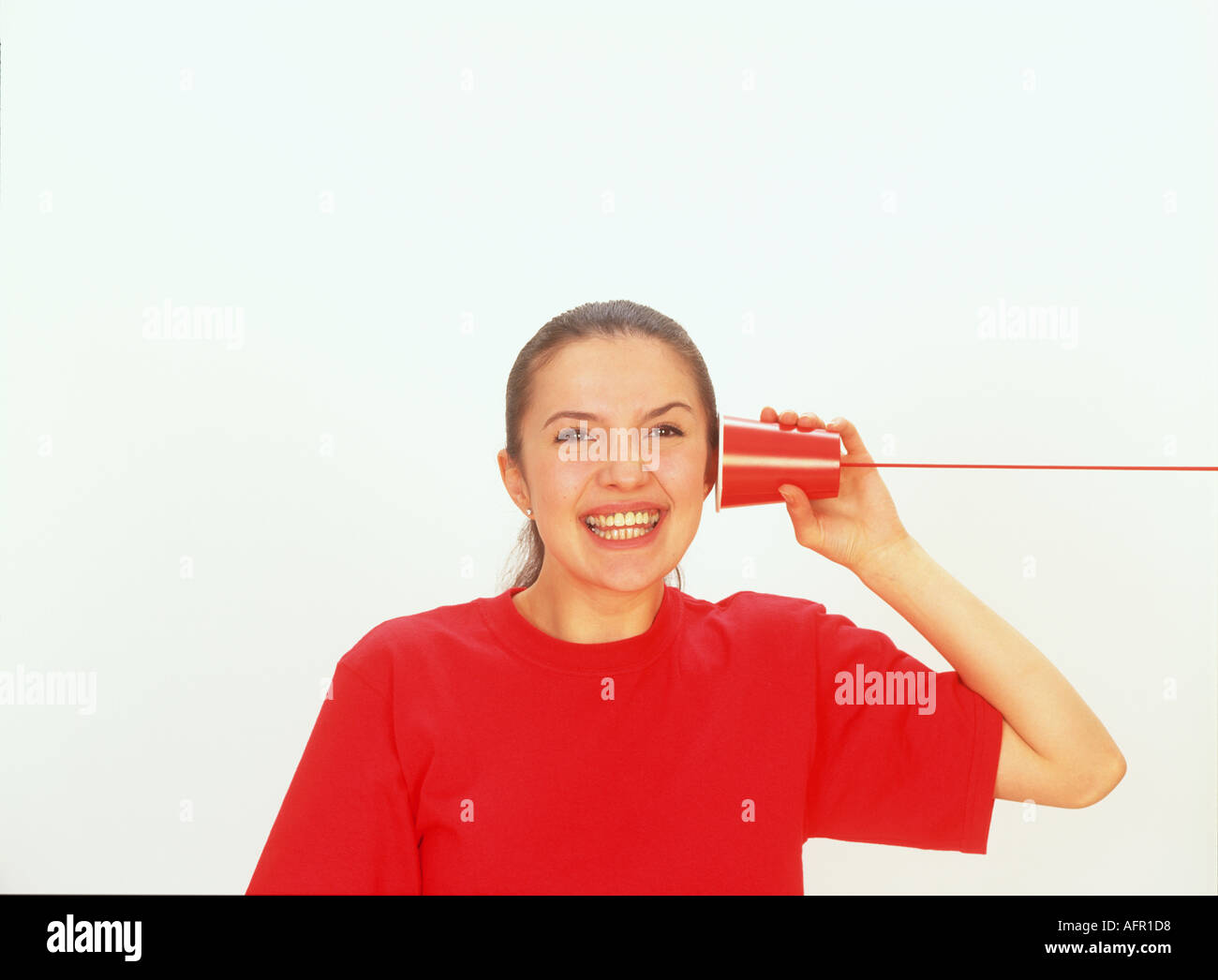 Western Woman Listening on String Telephone Stock Photo - Alamy