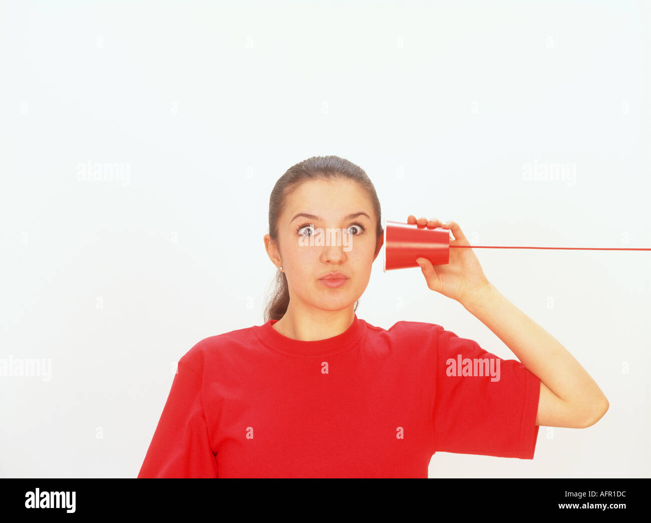 Western Woman Listening on String Telephone Stock Photo - Alamy