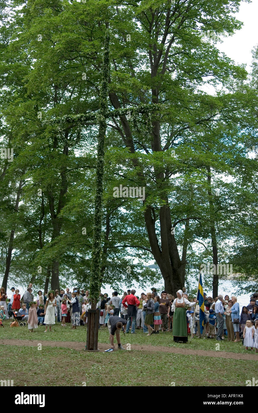 Rising of a maypole in Sweden Stock Photo - Alamy