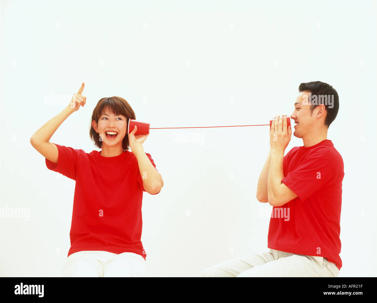 Couple on String Telephone Stock Photo - Alamy