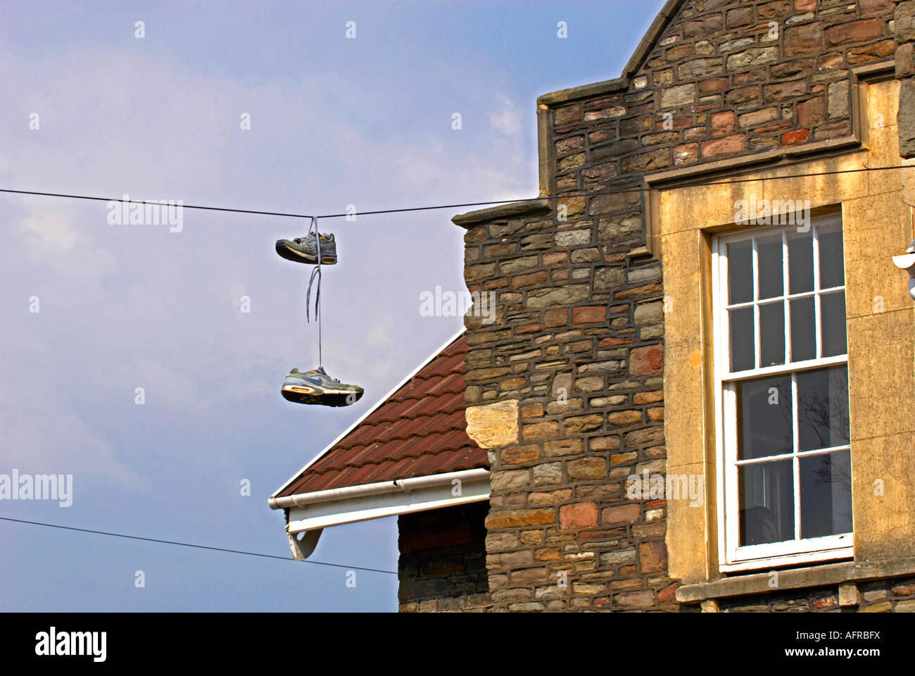 Trainers discarded in an unusual way on a telephone wire Stock Photo ...