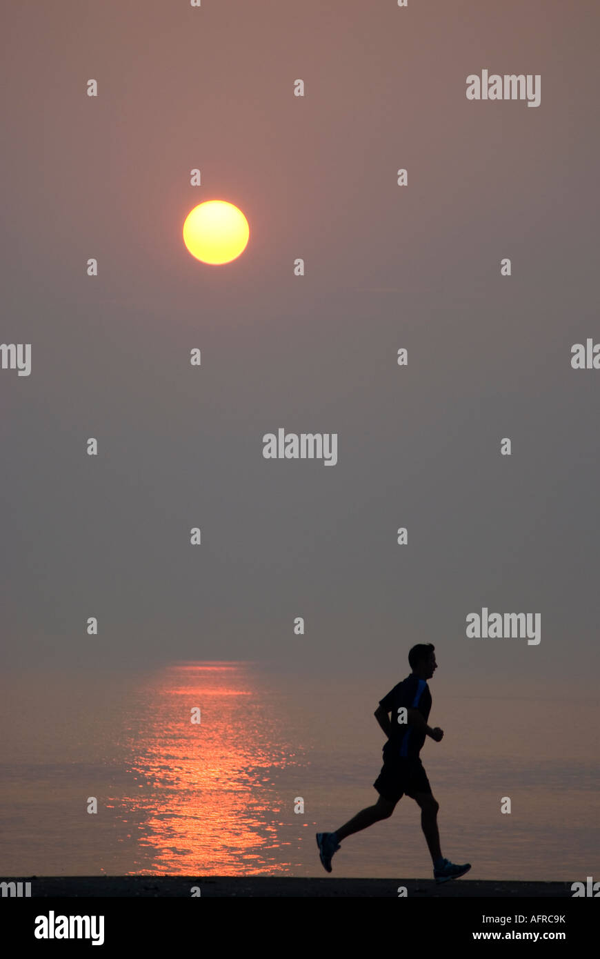 Jogging at sunrise Stock Photo - Alamy