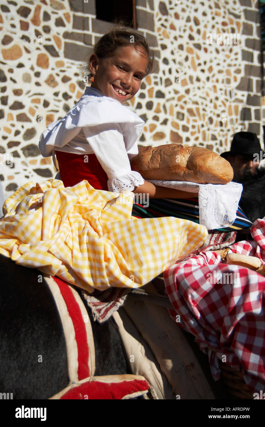 Young Spanish girl on donkey at fiesta del Pino in Teror on Gran ...