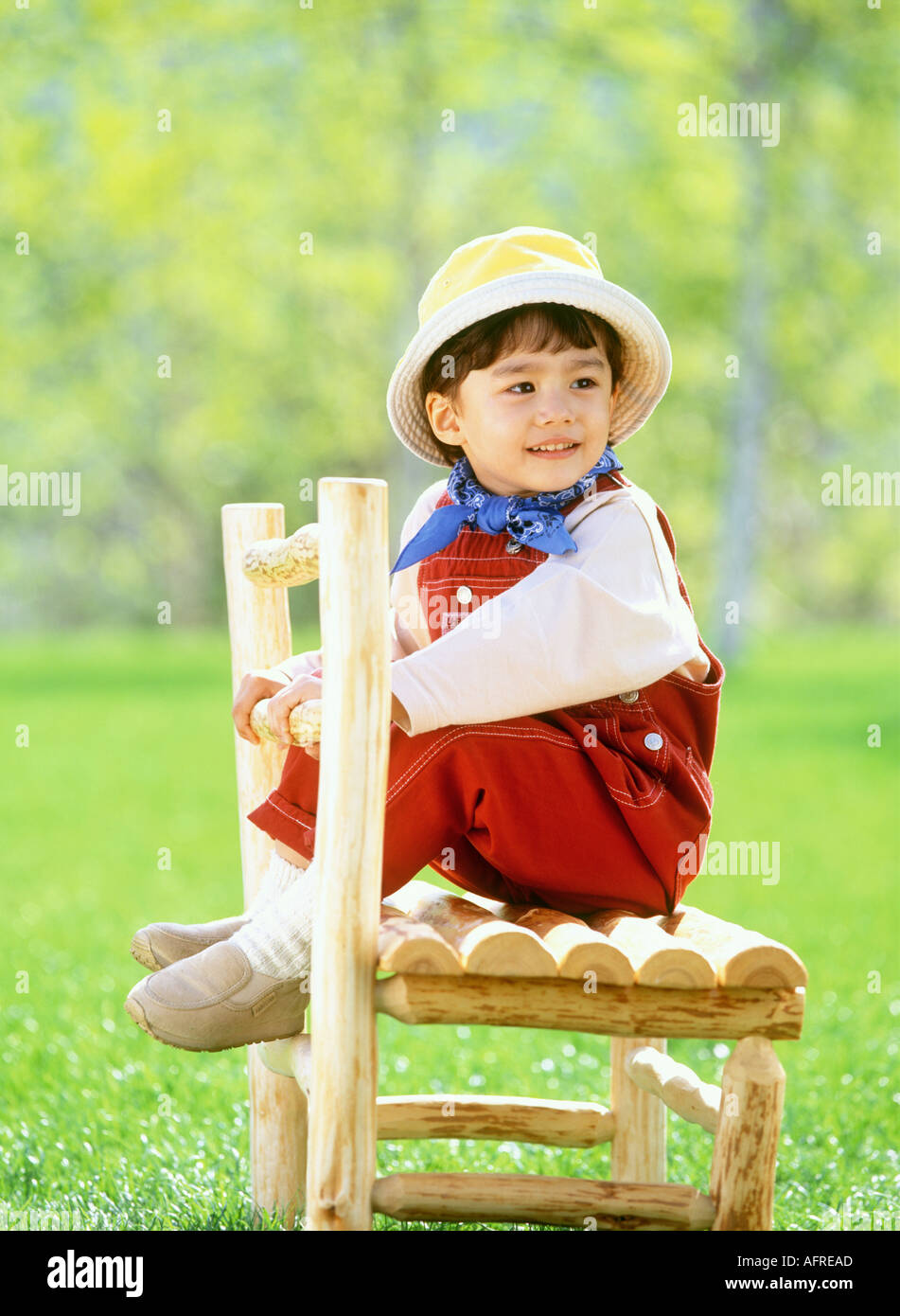 Boy Sitting on Chair Stock Photo - Alamy