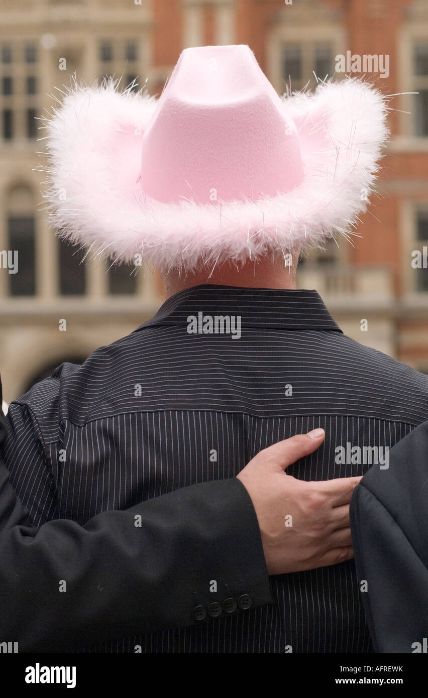 LGBT+ UK, two gay men back view, one is wearing a pink hand, his ...