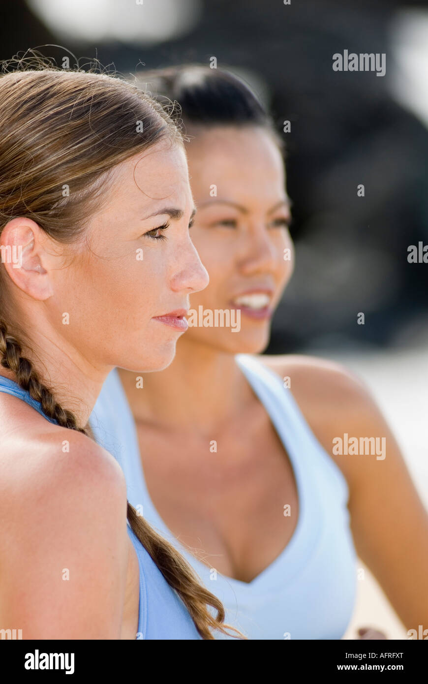Two women one with a look of concern and one smiling Stock Photo - Alamy