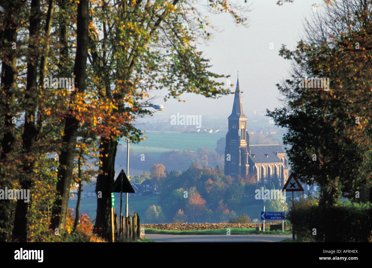 Netherlands Vijlen Trees with church in background Stock Photo - Alamy