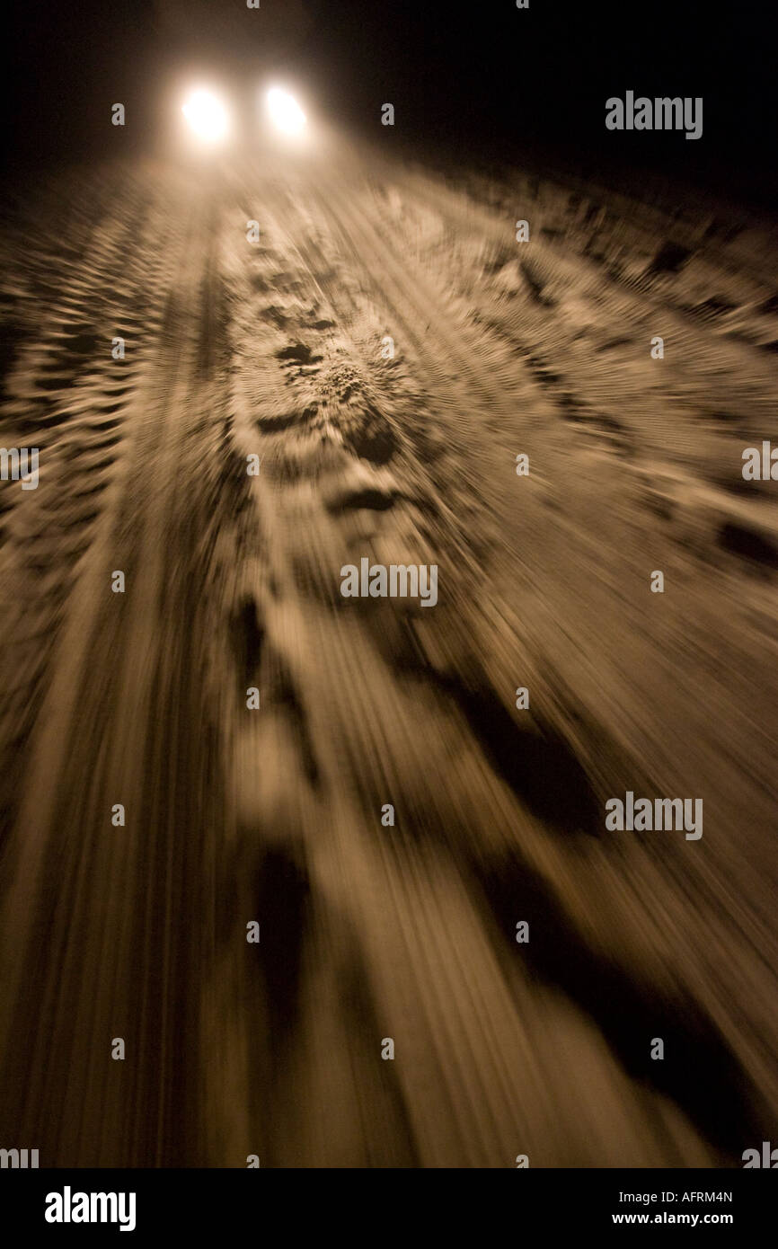 Off-road vehicles lighting a sandy road with its headlights Stock Photo ...