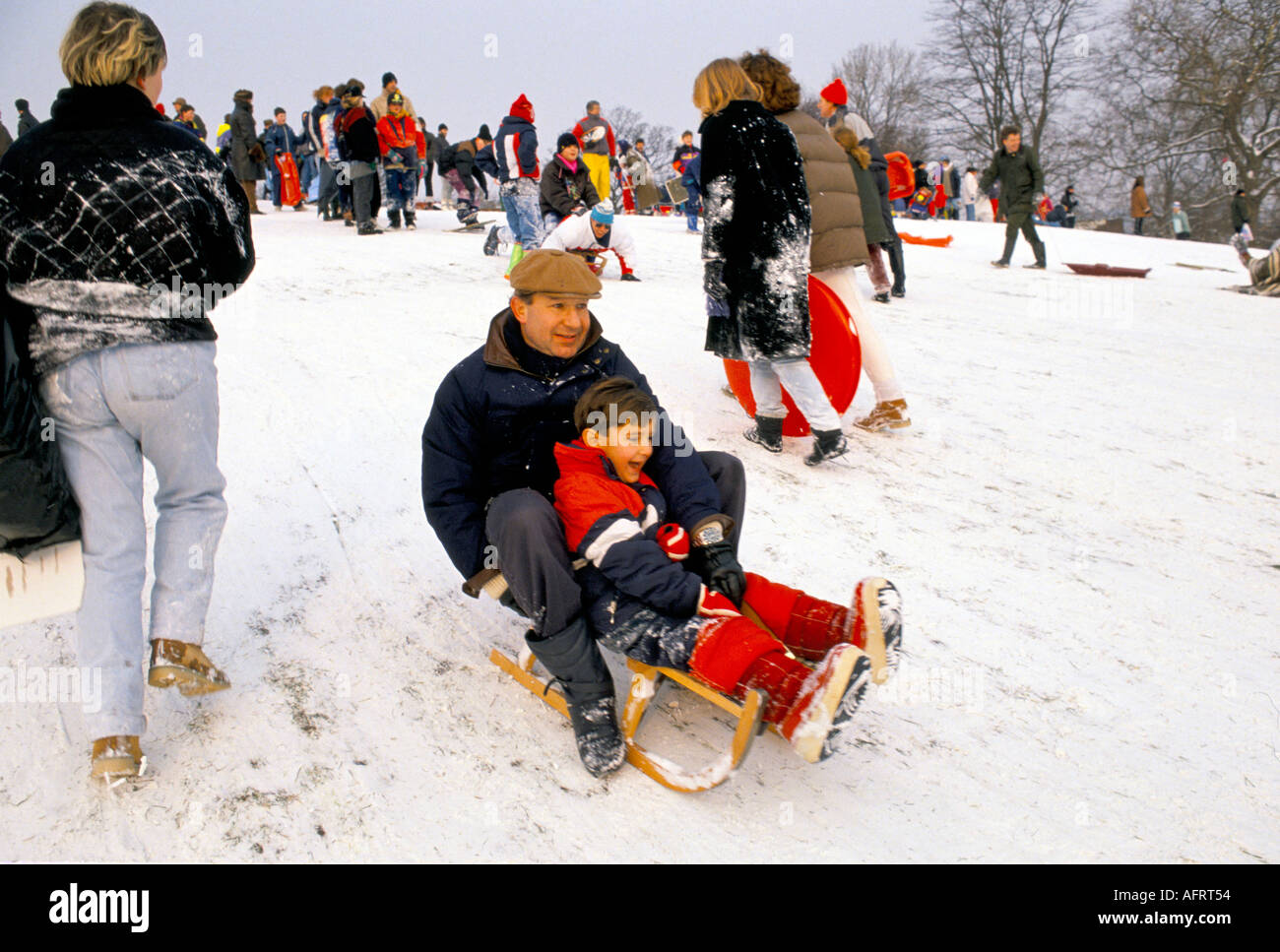 Snow UK 1990s in London families enjoying a white winter Primrose Hill ...