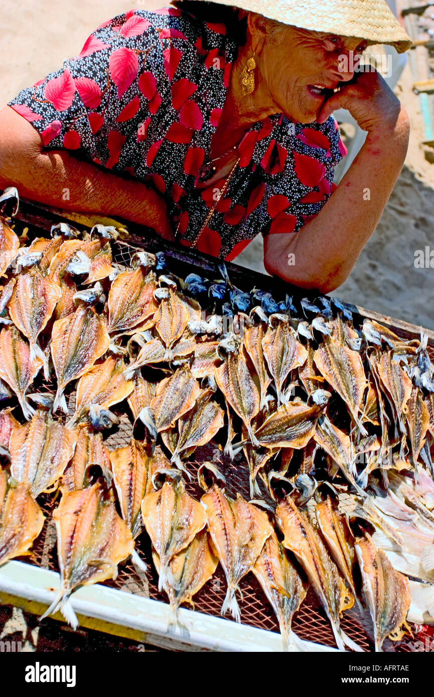 Fish drying and sellor woman at Nazare beach Portugal Stock Photo - Alamy