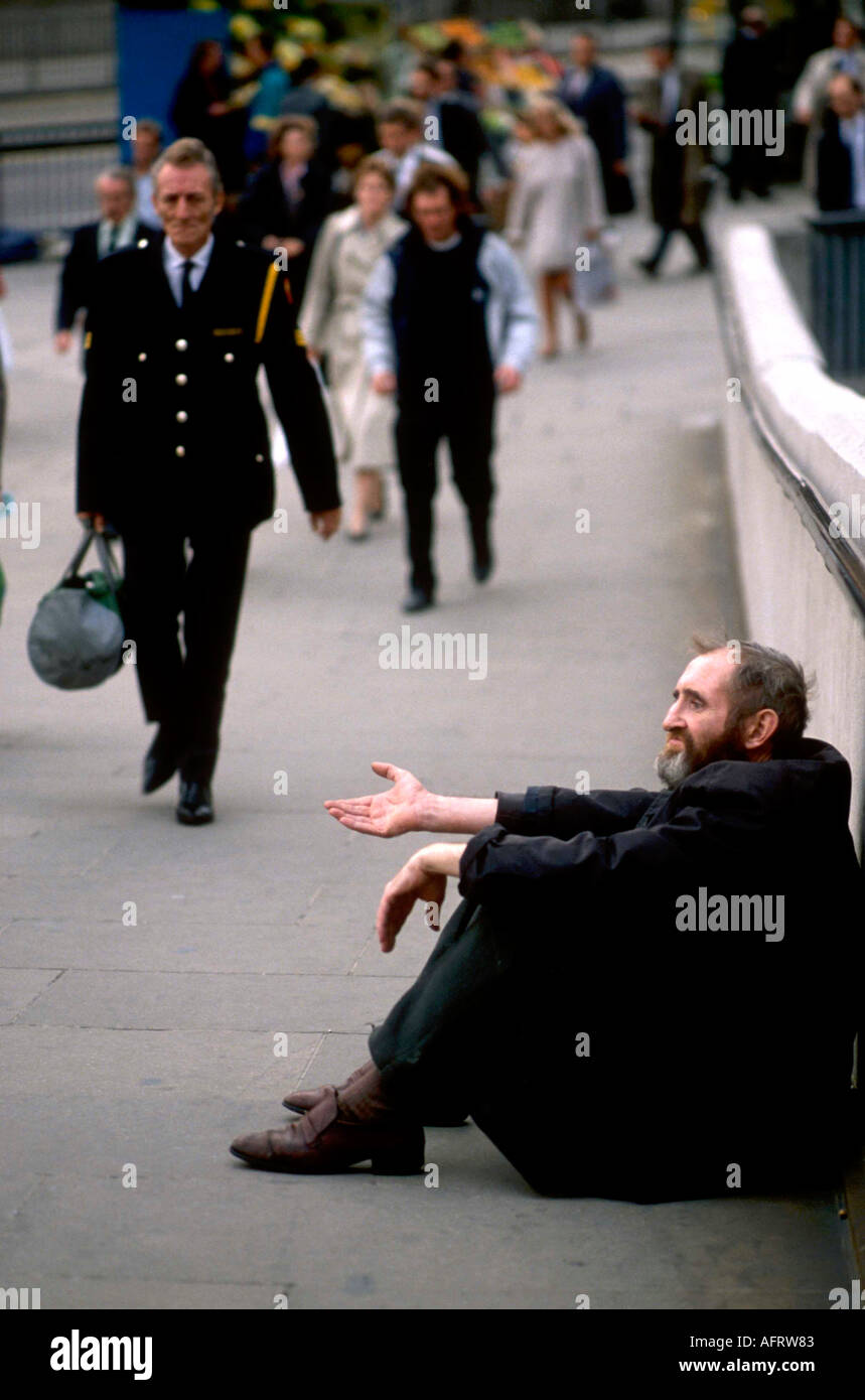 Elderly down and out man street begging on London Bridge from commuters ...