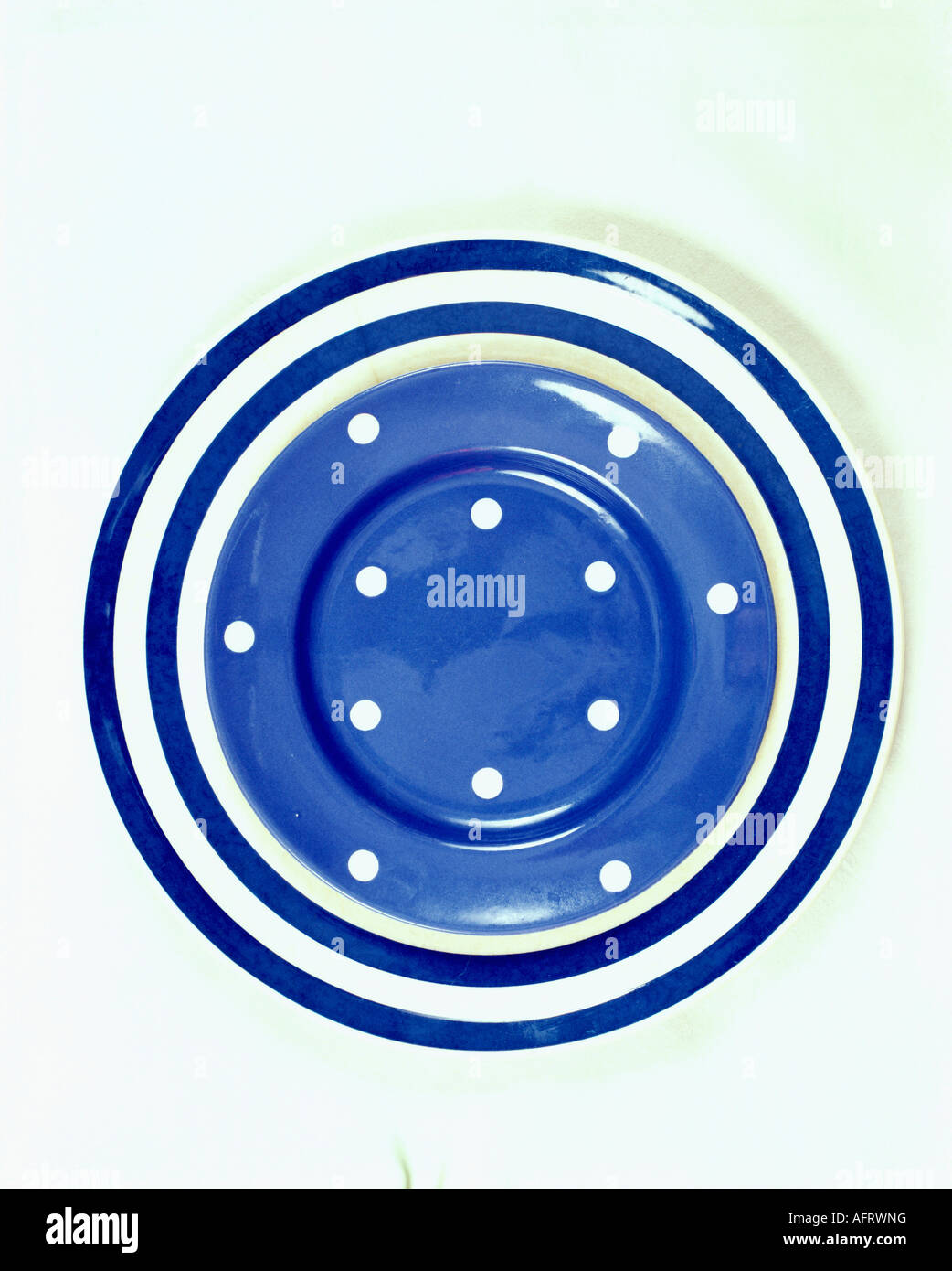 Close up of blue and white striped and spotted plate Stock Photo - Alamy