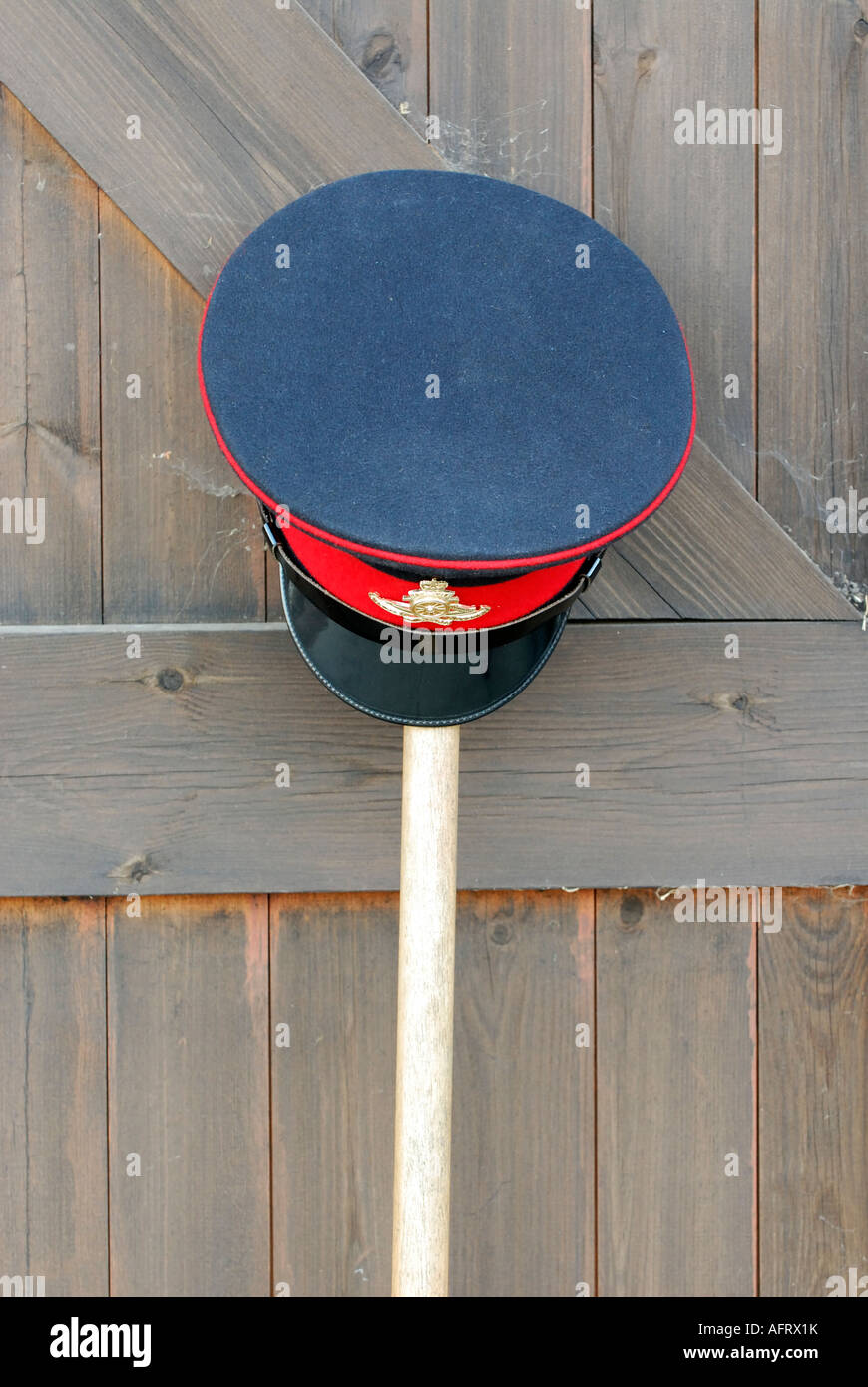 a royal artillery gunners peaked cap on a door peg hanging on a door of ...
