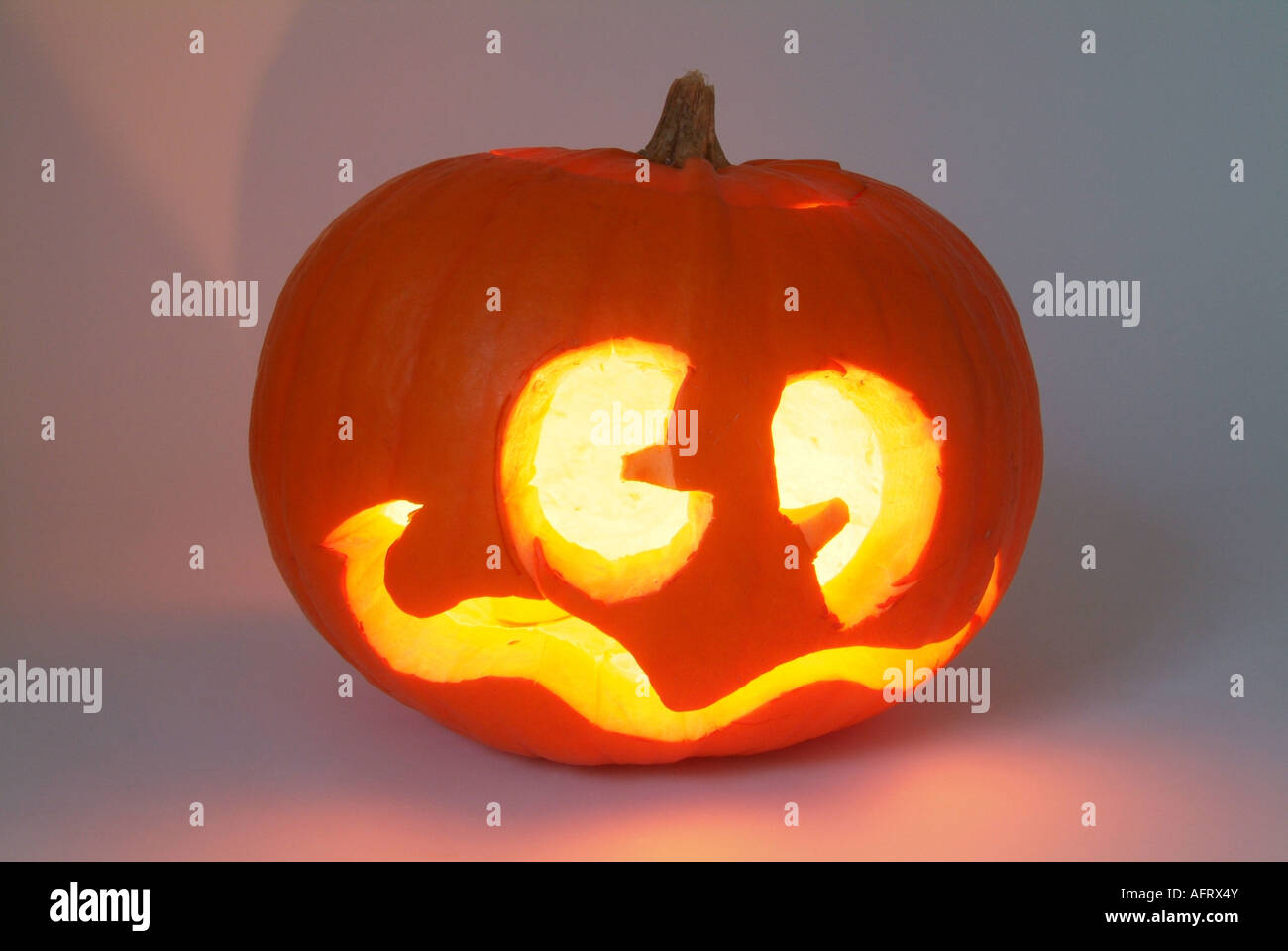 Illuminated Pumpkin - Silly Face Stock Photo - Alamy