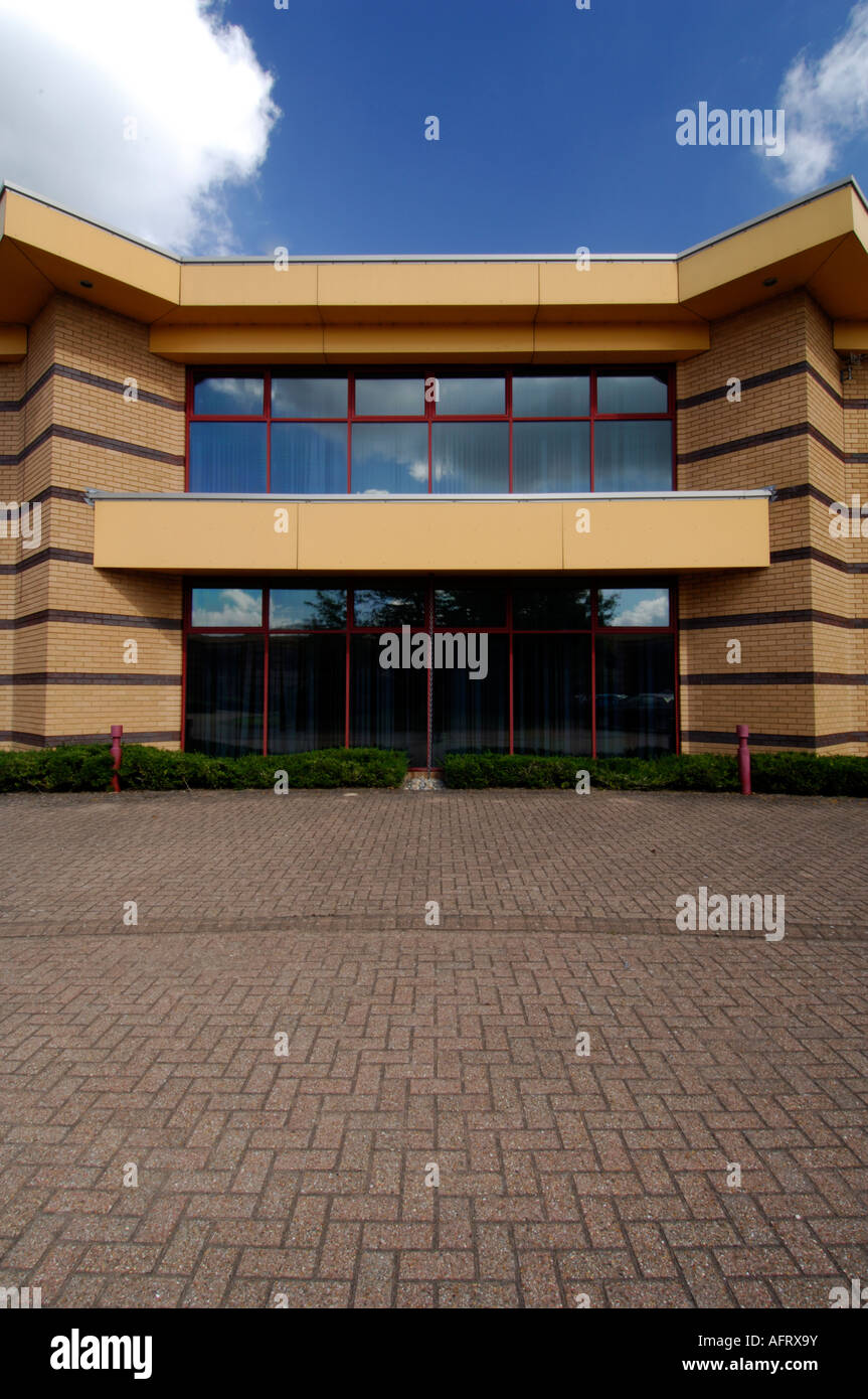 The front of a modern office building with a large foyer and smoked ...