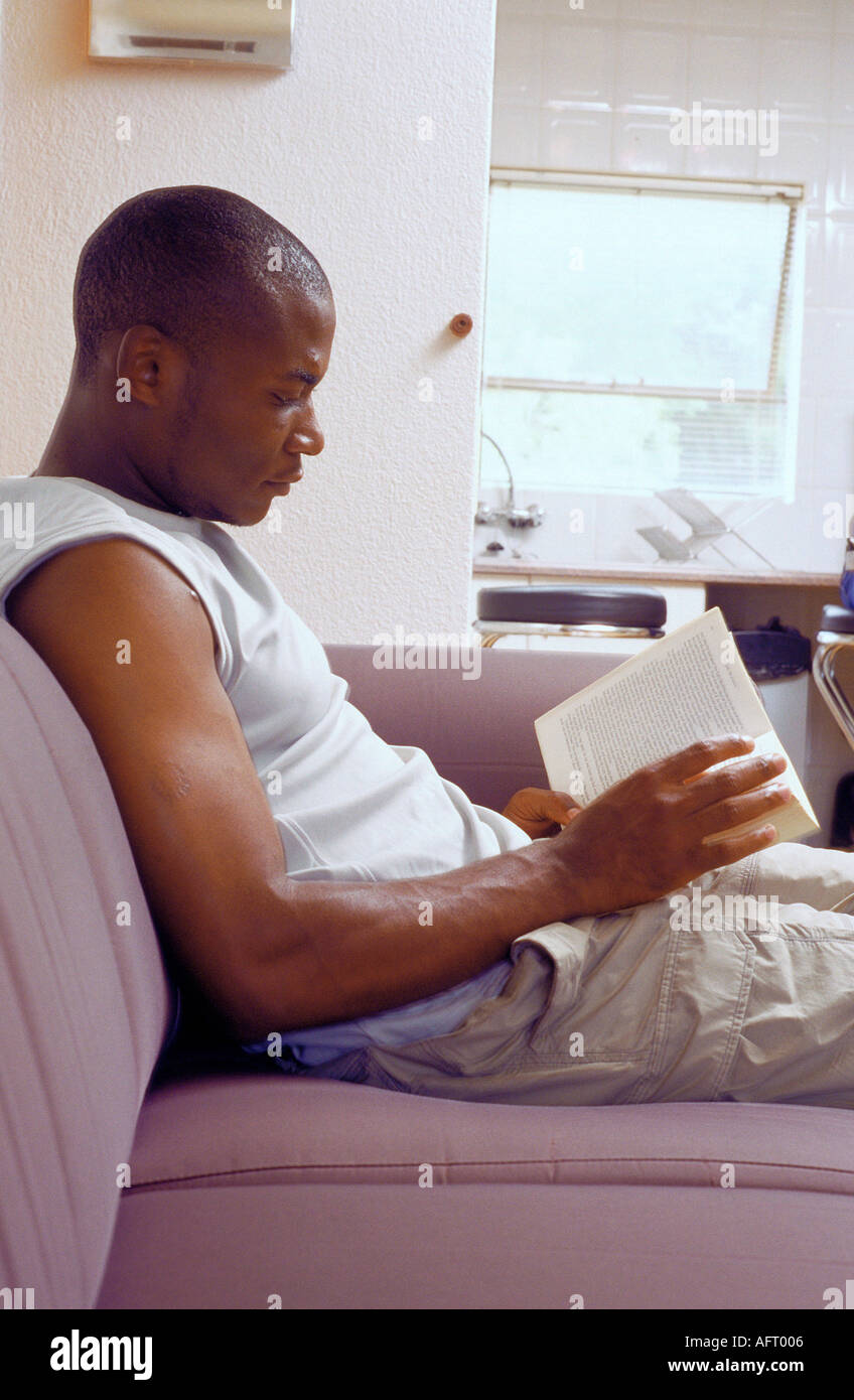Black man reading book Stock Photo - Alamy
