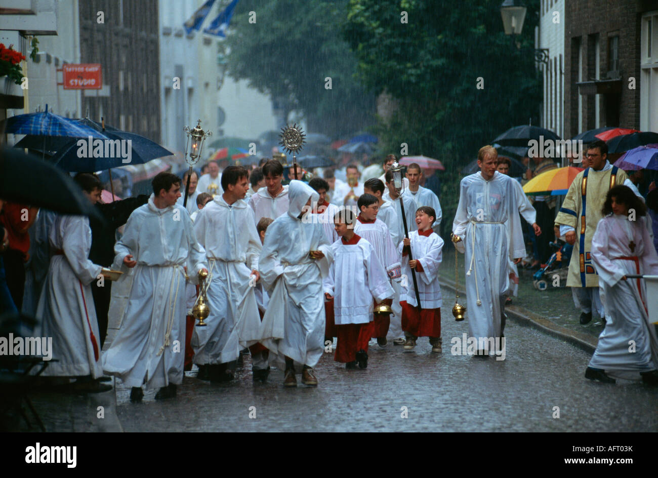 Netherlands Maastricht People in religious procession walking in rain ...