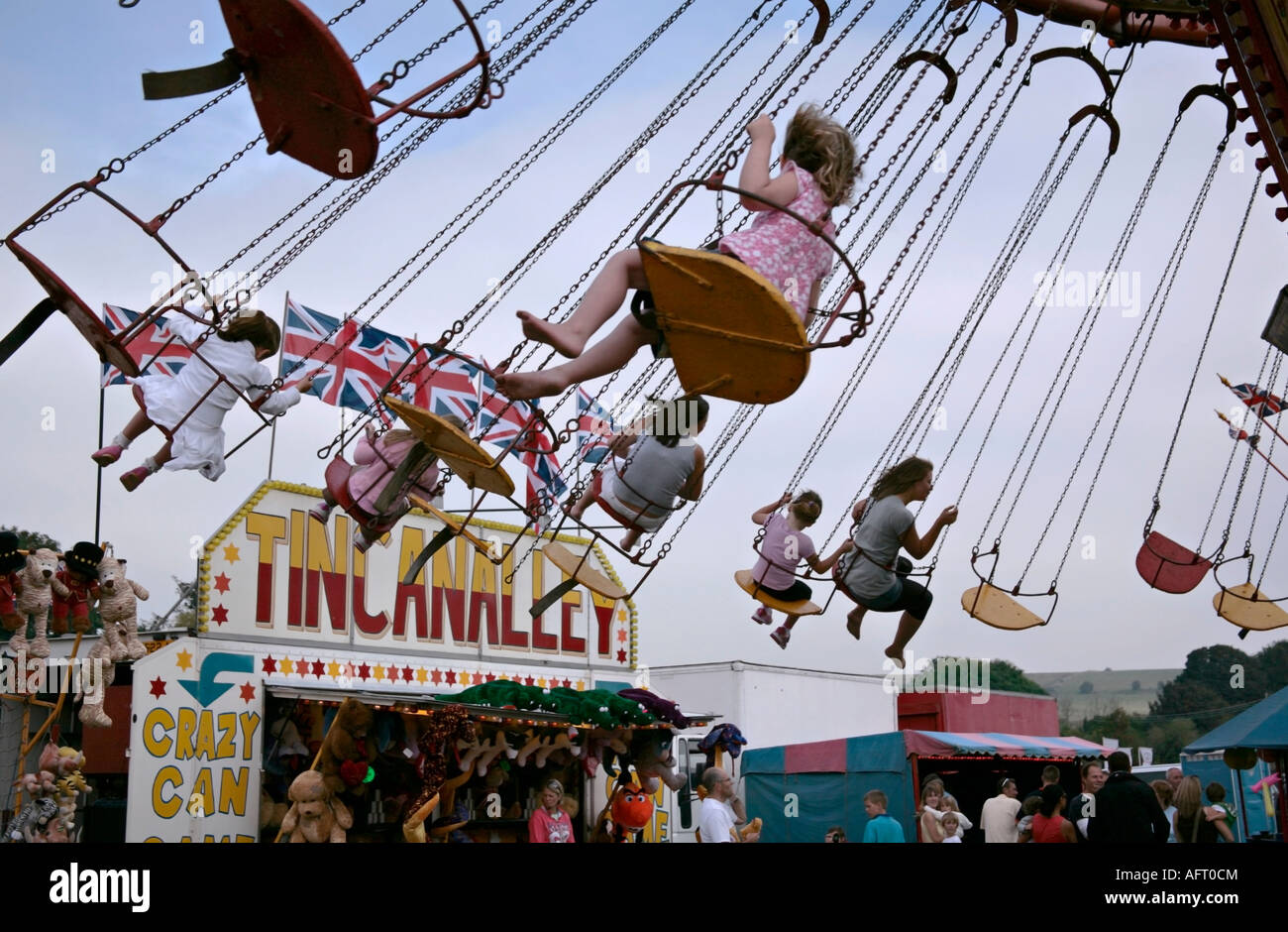 Kids on Chairoplanes ride at funfair Stock Photo - Alamy
