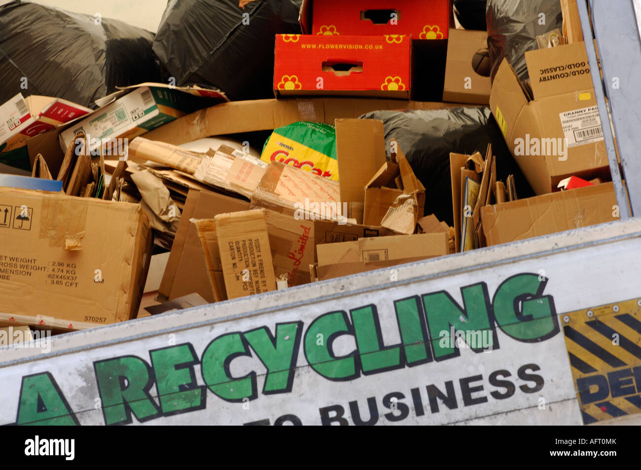 a recycling truck wagon vehicle dust cart full of cadbard and paper ...