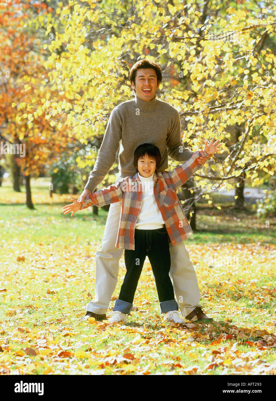 Father Son in Red Leaves Stock Photo - Alamy