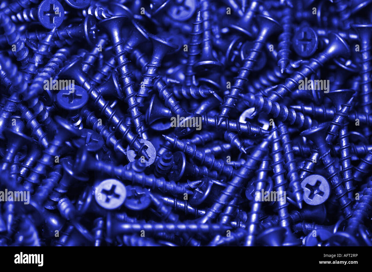 Blue screws in piles Stock Photo - Alamy