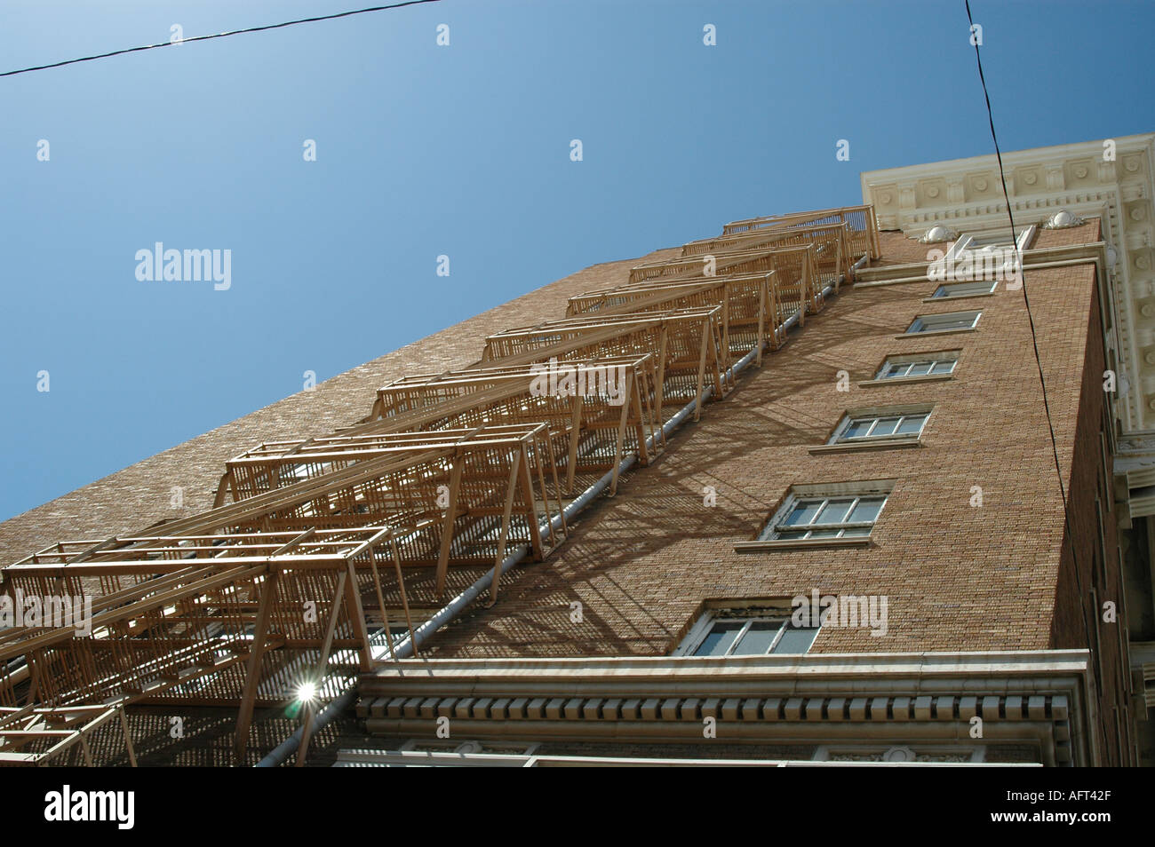 Fire escape on side of brick building Dramatic angle looking up Stock ...