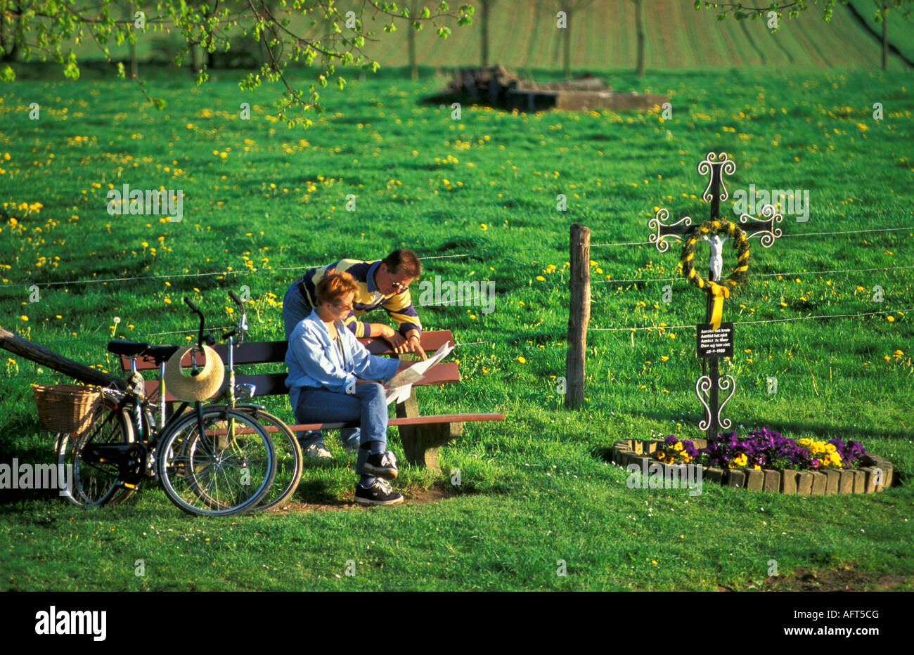 Netherlands Margraten Cyclists taking rest on bench Stock Photo - Alamy