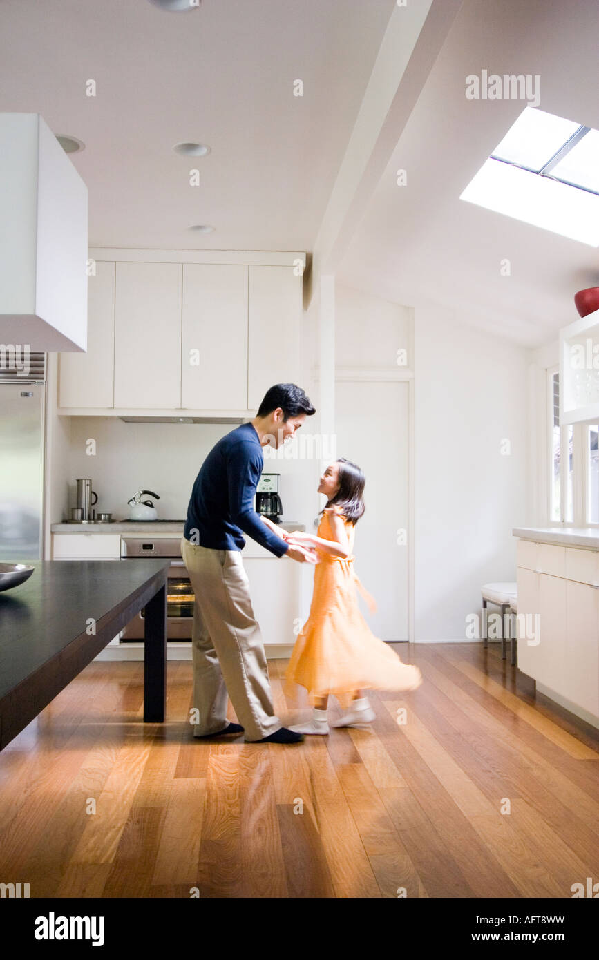 Father and Daughter Dance in the Kitchen of their Modern Home Stock ...
