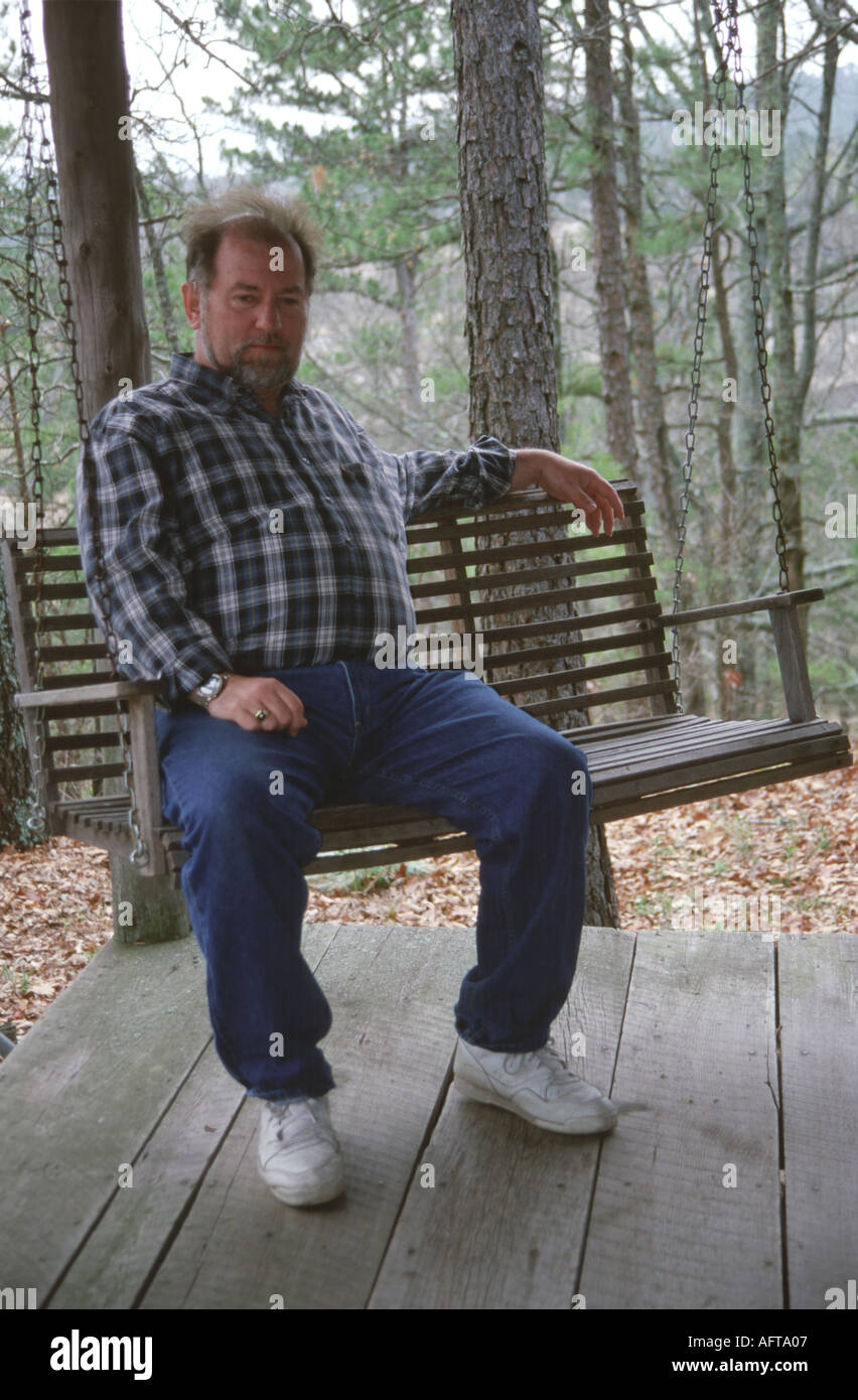 Sad Man on Porch Swing Stock Photo - Alamy