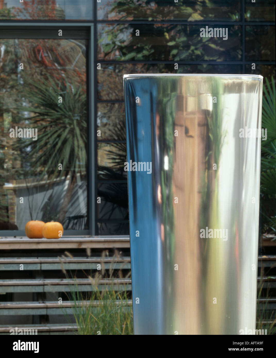 Modern House Extension, W12. Detail of sculpture in garden with ...