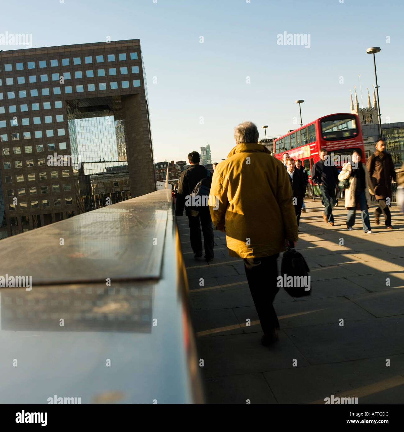 Going to work early morning office workers walking over London Bridge ...