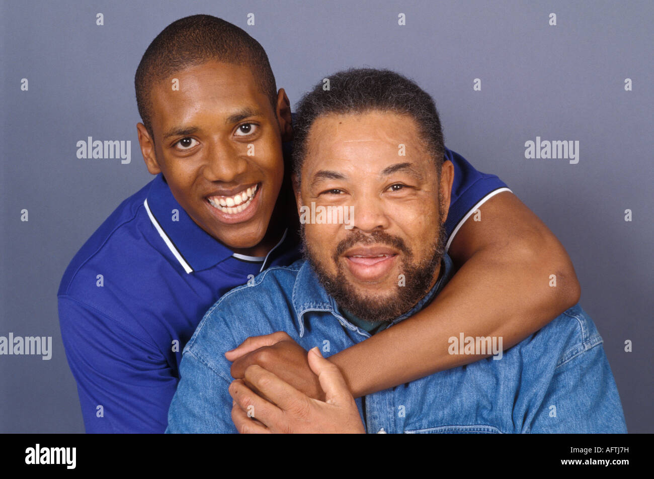 Son embracing father, smiling, portrait Stock Photo - Alamy