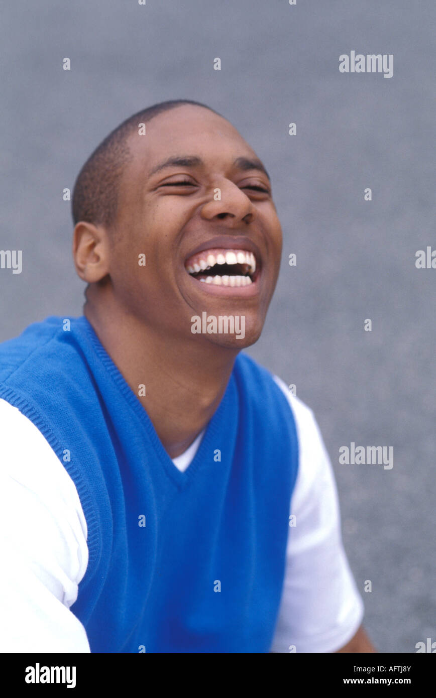 Young man laughing Stock Photo - Alamy