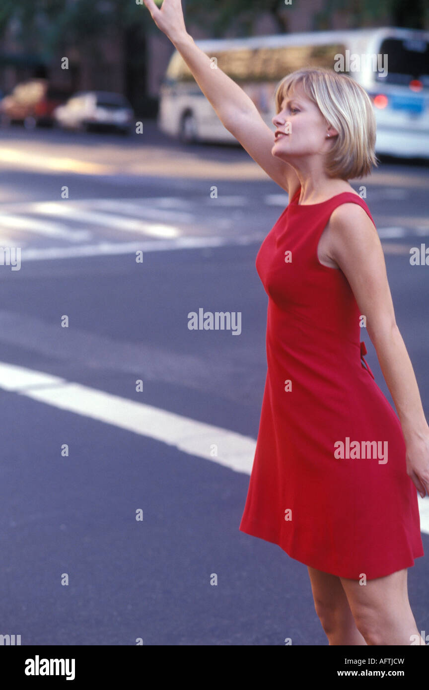 Young woman waving Stock Photo - Alamy