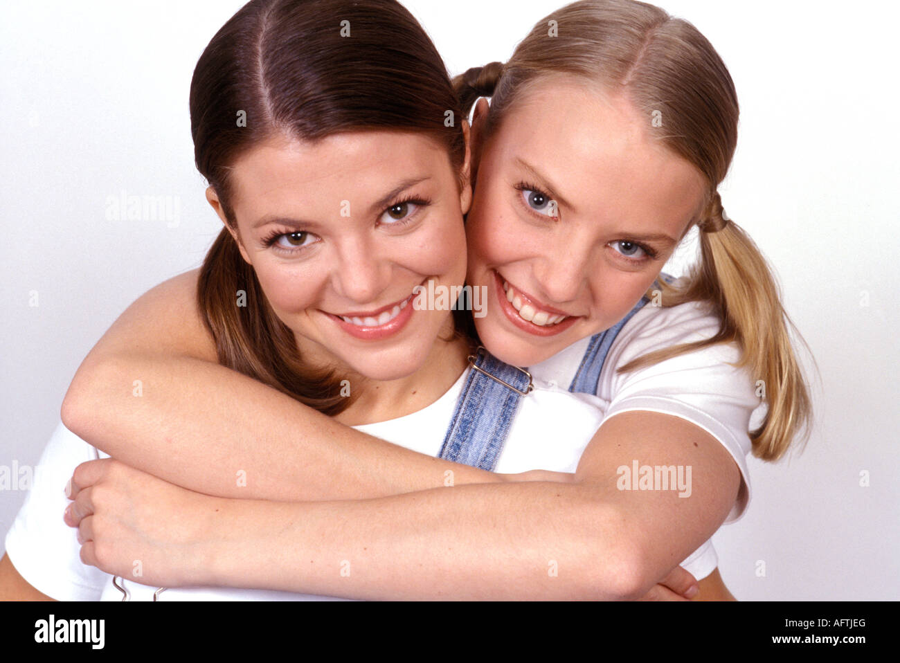 Sisters embracing, smiling, portrait Stock Photo - Alamy