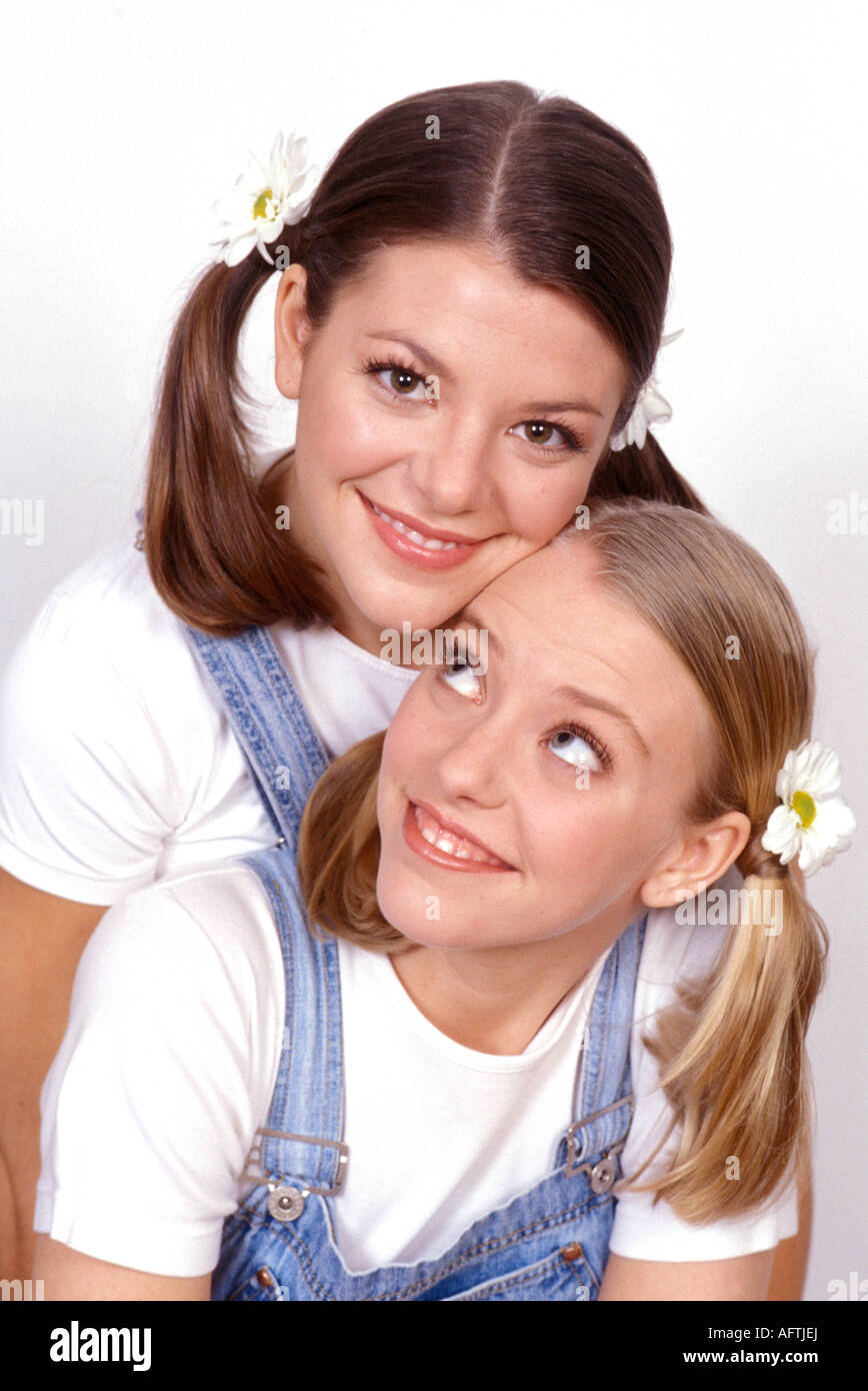 Sisters embracing, smiling, portrait Stock Photo - Alamy