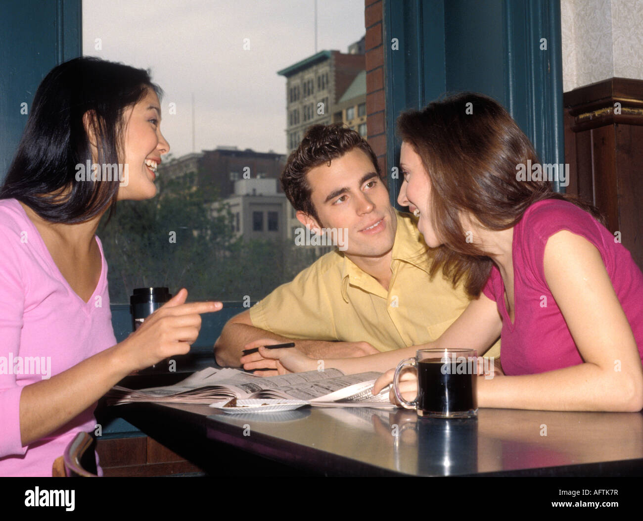 Friends sitting in coffee shop, side view Stock Photo - Alamy