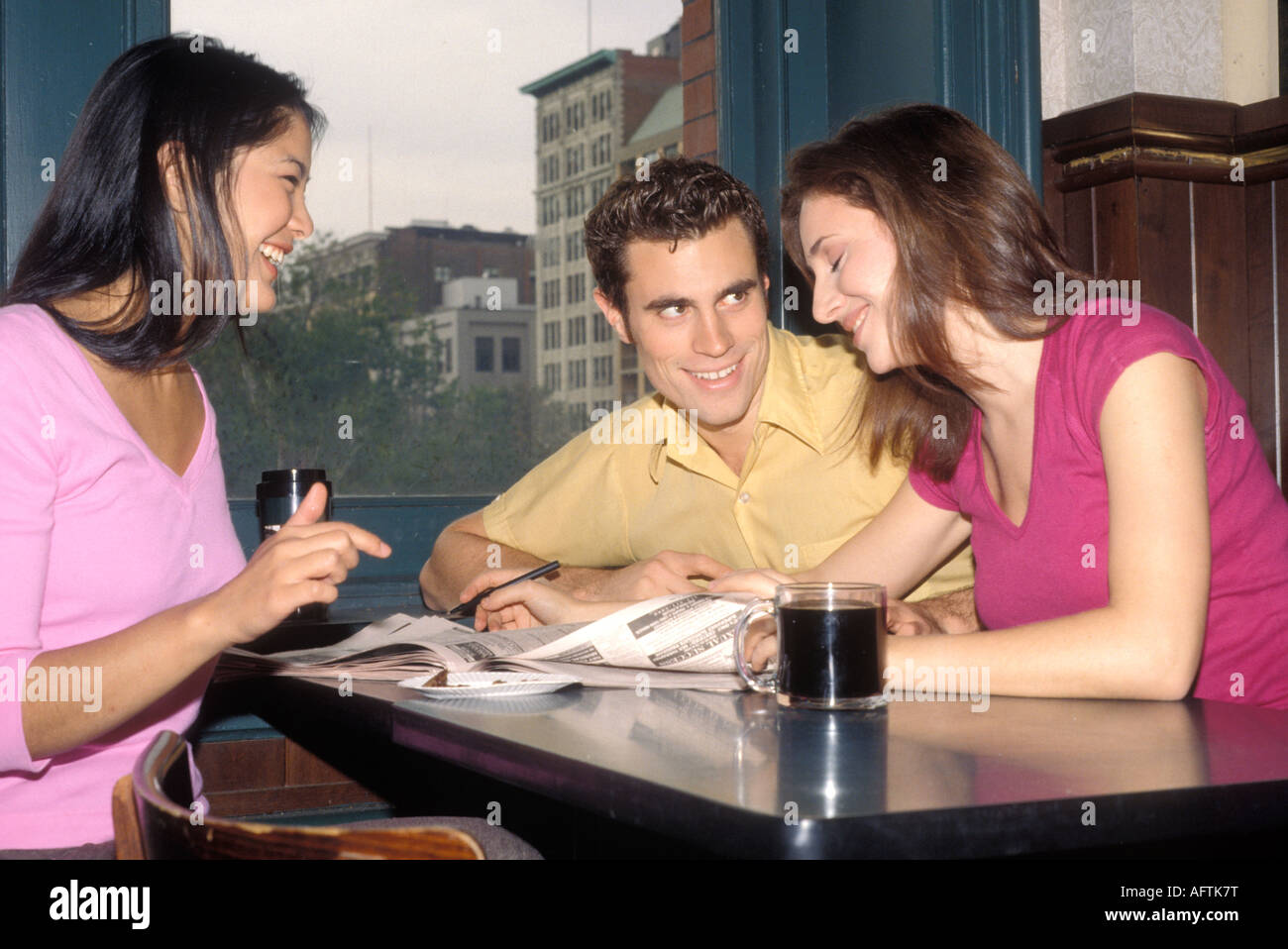 Friends sitting in coffee shop, side view Stock Photo - Alamy